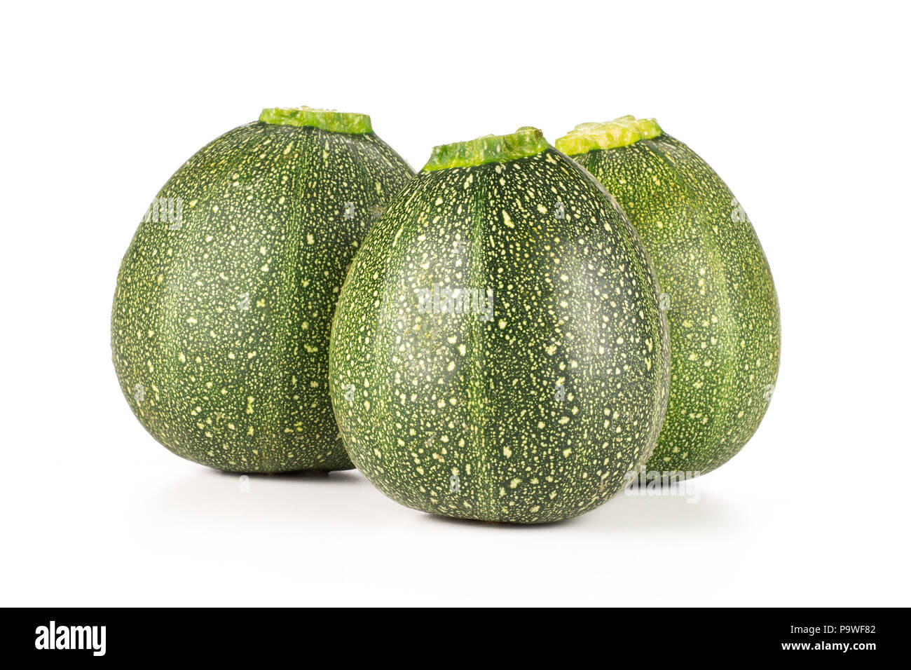 Round zucchini isolated on white background three fresh summer squash ...