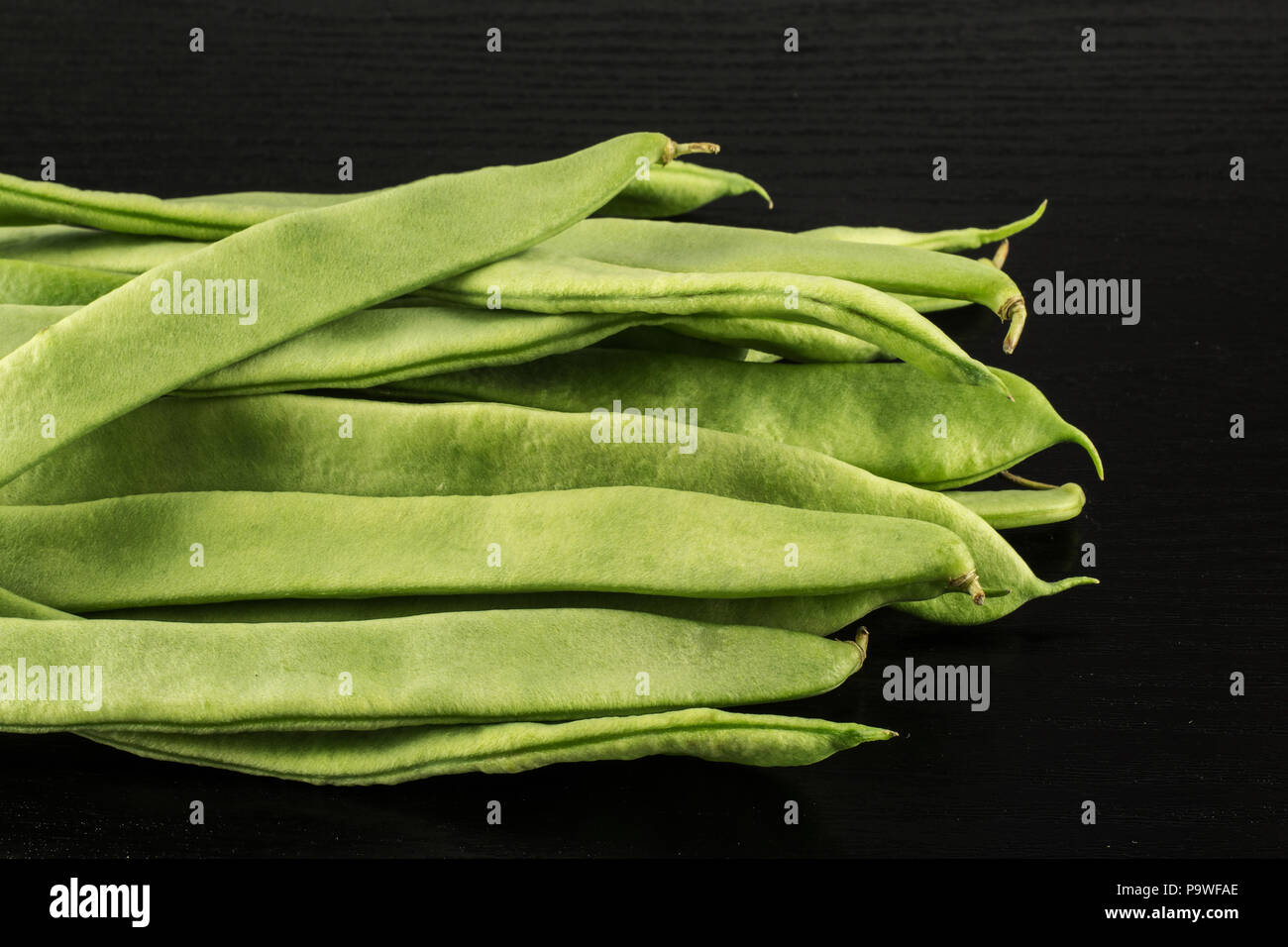 Flat green beans top view isolated on black wood background Stock Photo ...