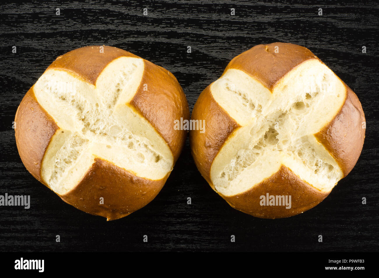 Bavarian bread buns top view on black wood background two fresh baked ...