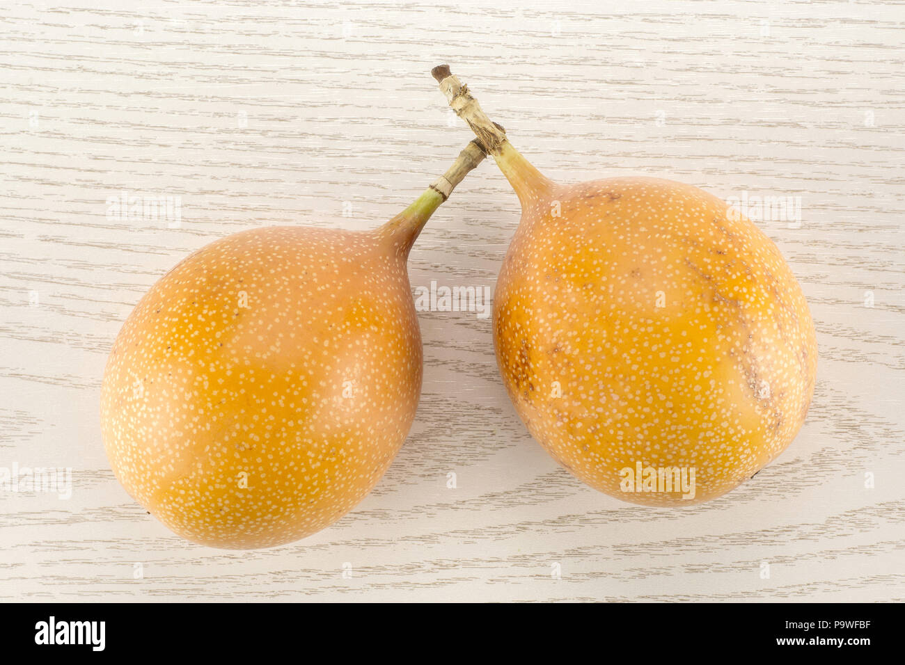 Two giant grenadilla table top isolated on grey wood background sweet ...