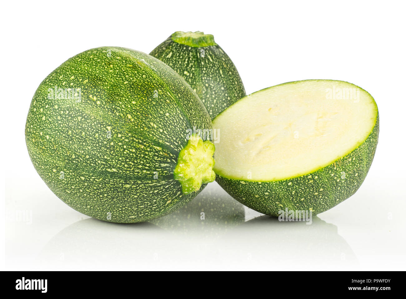 Two round zucchini and one section half isolated on white background ...
