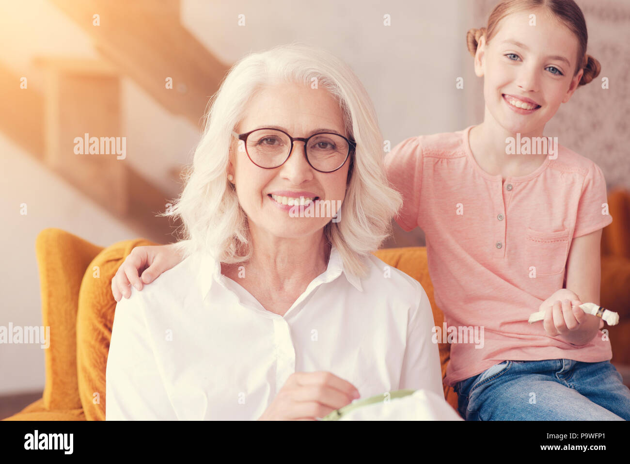 Family ties. Positive minded young lady embracing her beautiful granny ...