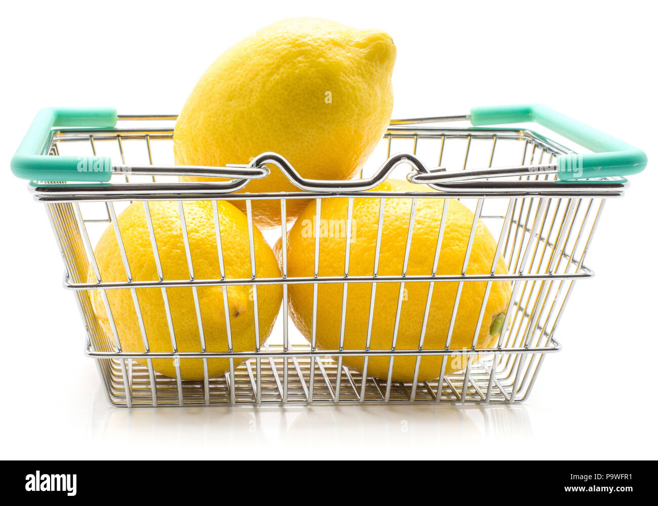Three yellow lemons in a shopping basket isolated on white background ...