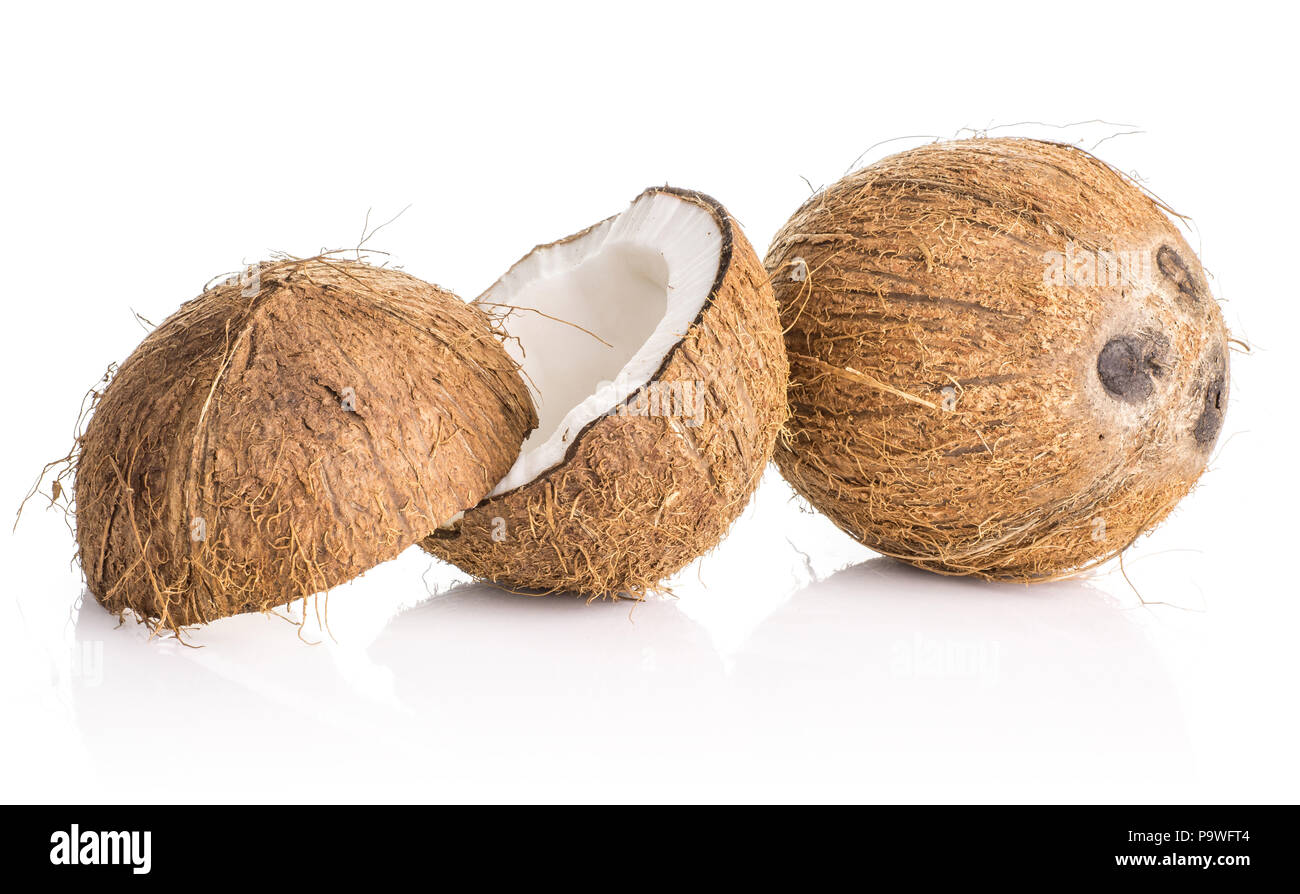 Two coconuts one sliced isolated on white background brown fibrous ...