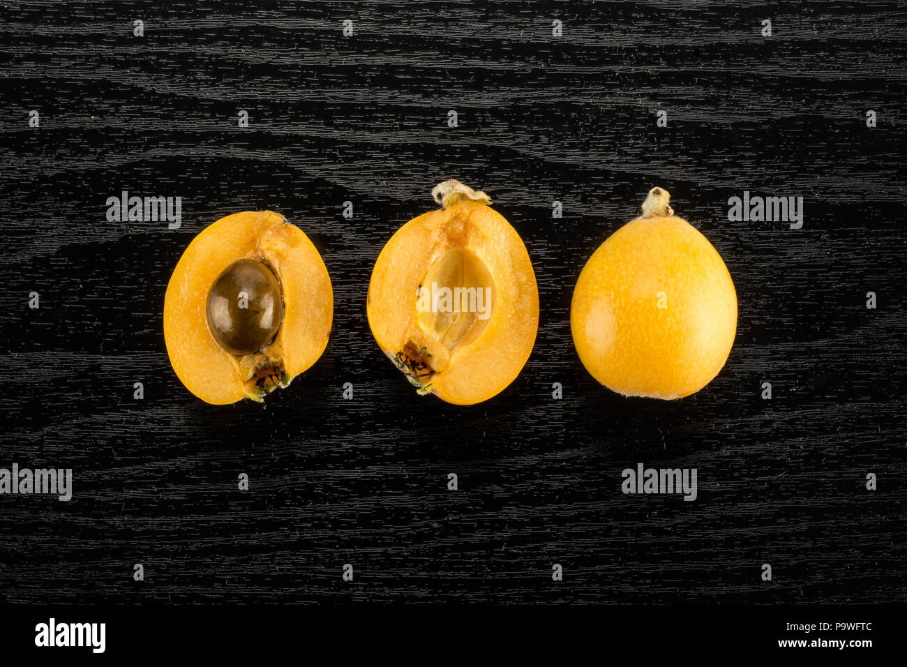 Fresh orange Japanese loquats collection top view isolated on black ...