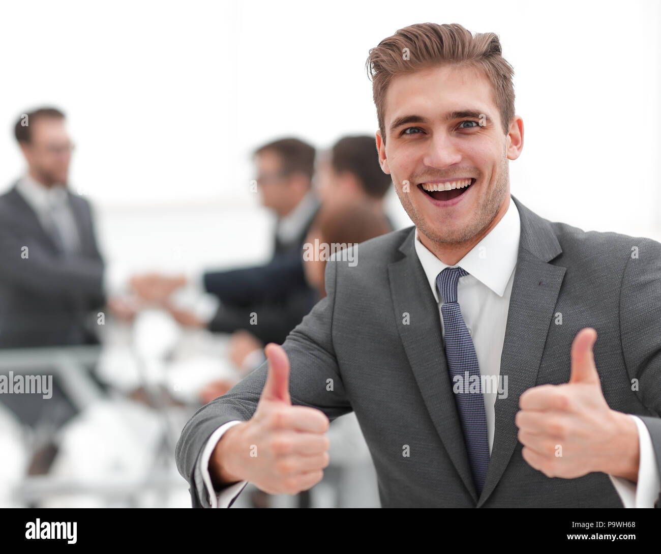 Portrait of happy energetic businessman with thumbs up while co Stock ...