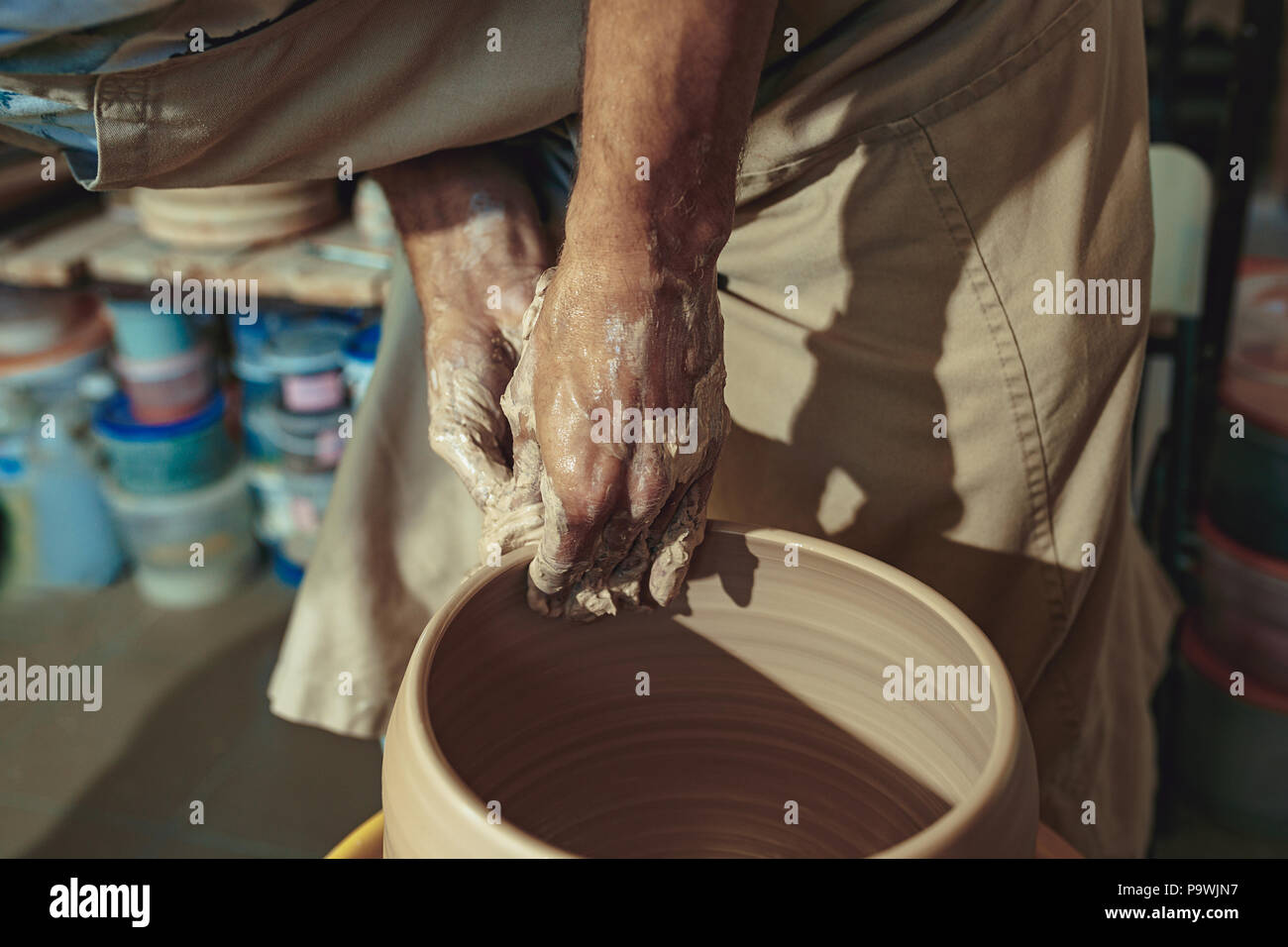 Creating a jar or vase of white clay close-up. Master crock Stock Photo ...
