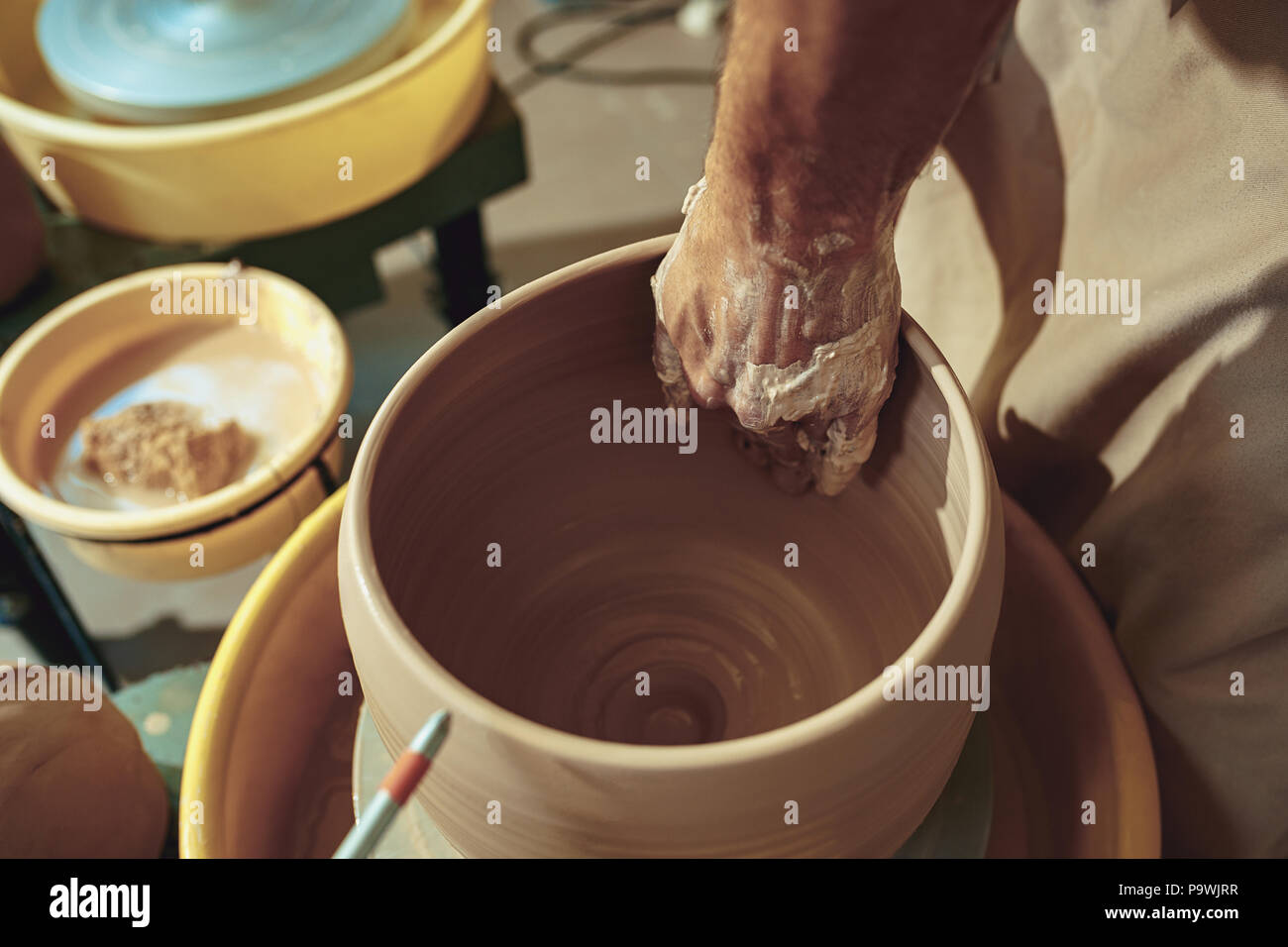 Creating a jar or vase of white clay close-up. Master crock Stock Photo ...