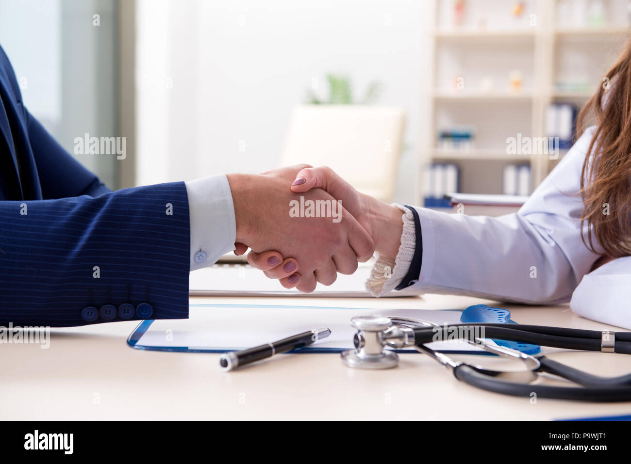 Man signing medical insurance contract Stock Photo - Alamy