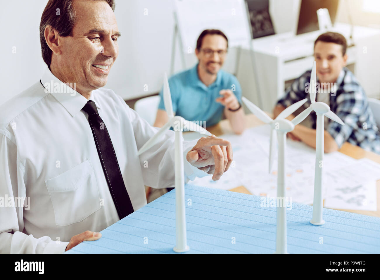 Smart manager. Positive engineers looking at the modern project of ...