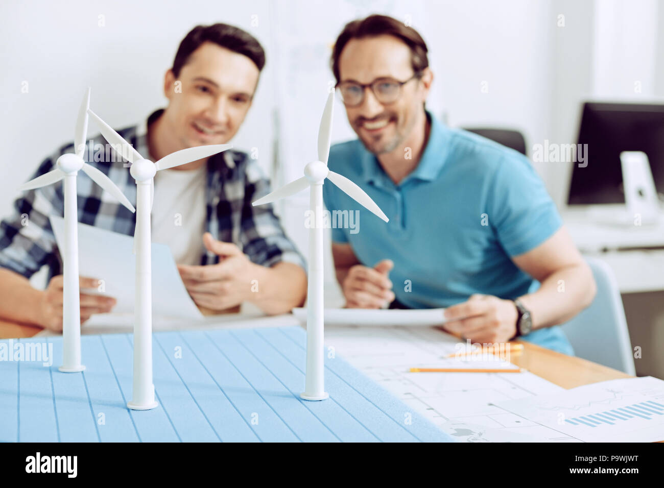 Positive coworkers. Happy friendly cheerful engineers sitting in their ...