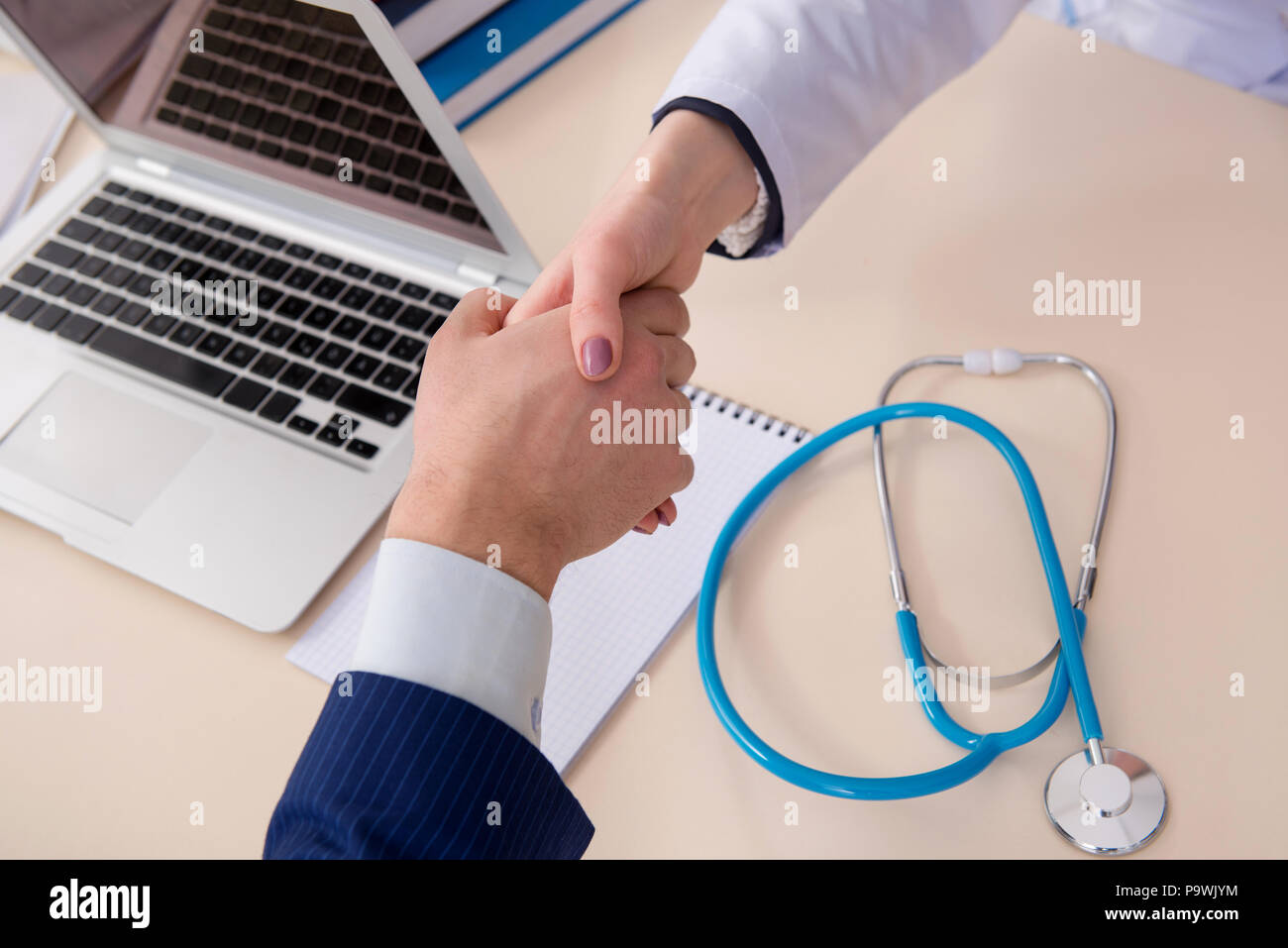 Man signing medical insurance contract Stock Photo - Alamy