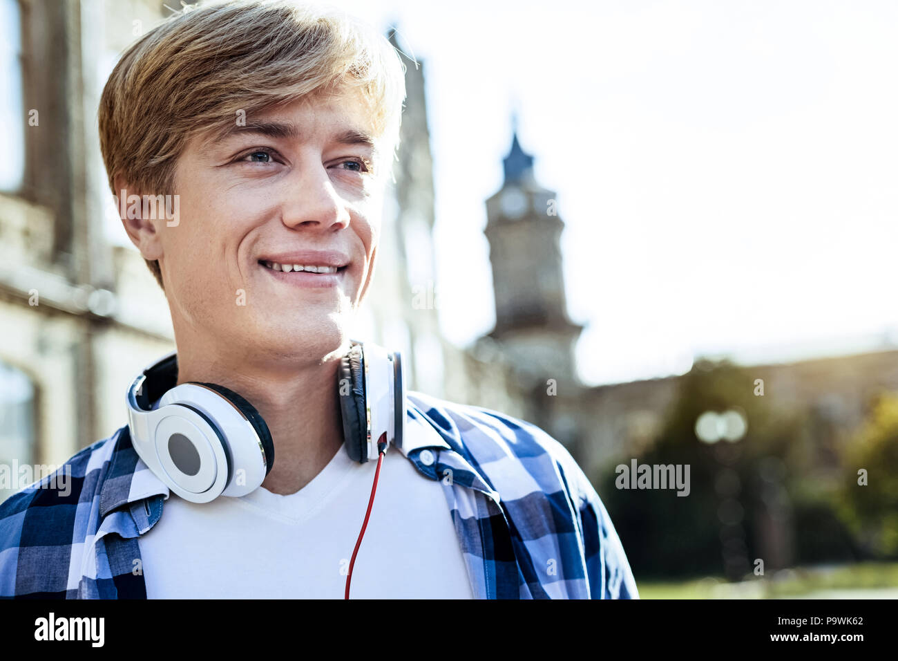 Facial expressions. Handsome male person keeping smile on his face ...