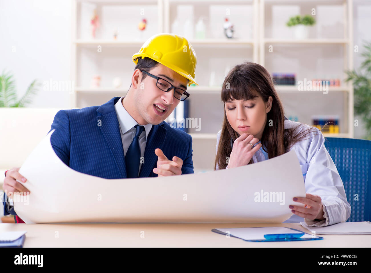 Doctor discussing new hospital plan with architect Stock Photo - Alamy