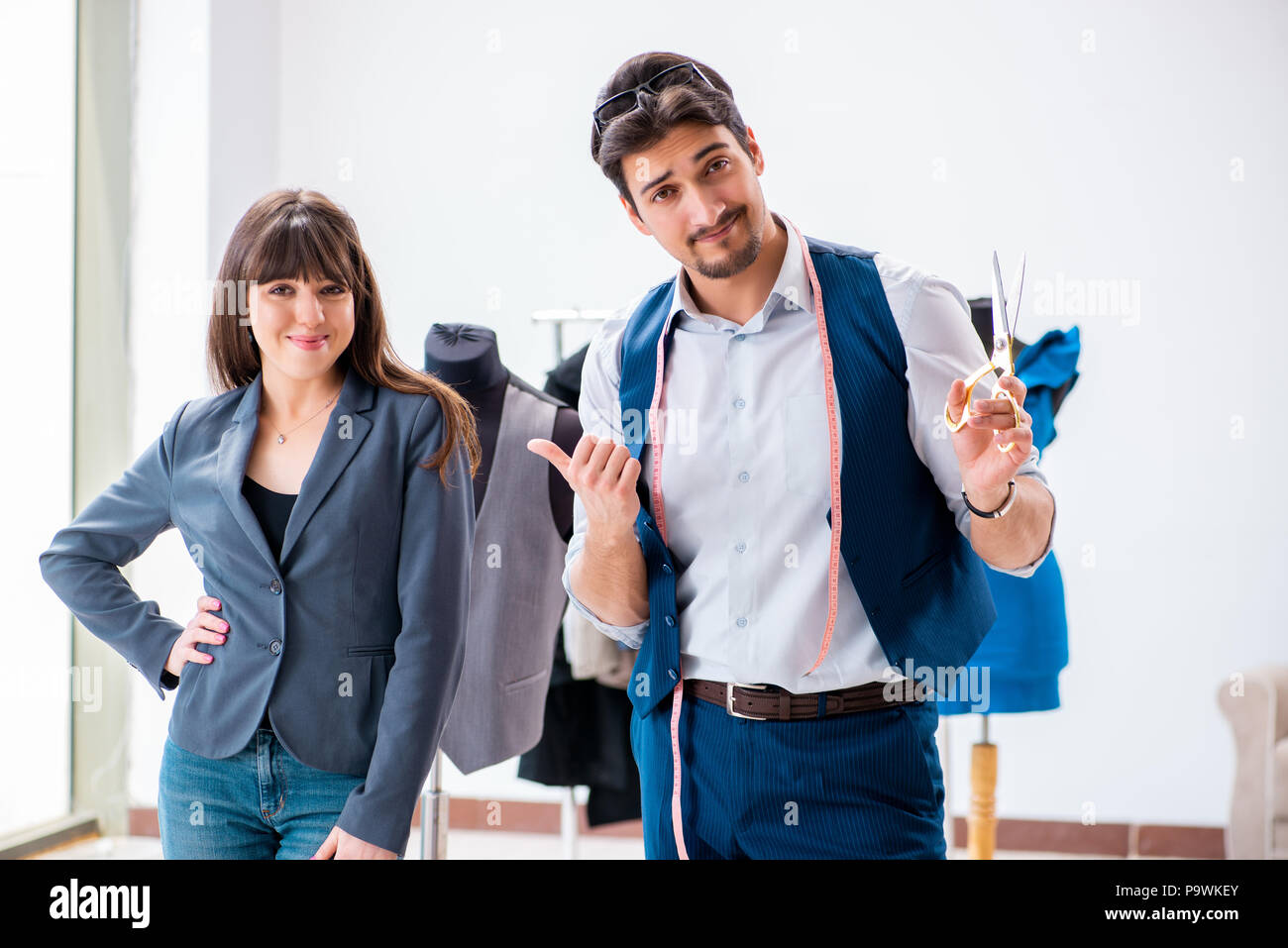 Professional tailor taking measurements for formal suit Stock Photo - Alamy