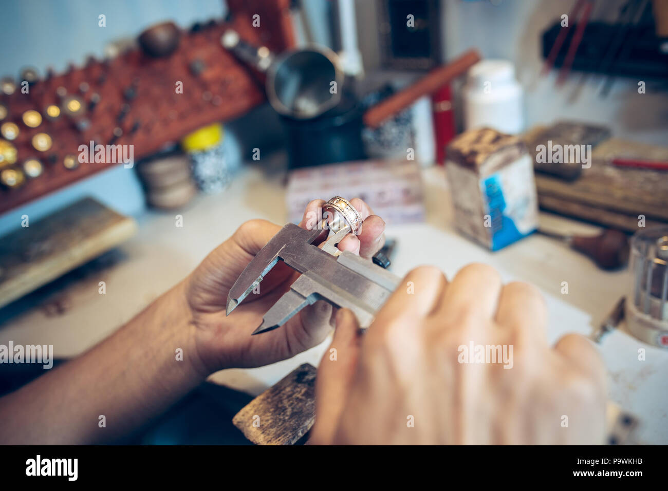 Different goldsmiths tools on the jewelry workplace. Jeweler at work in ...