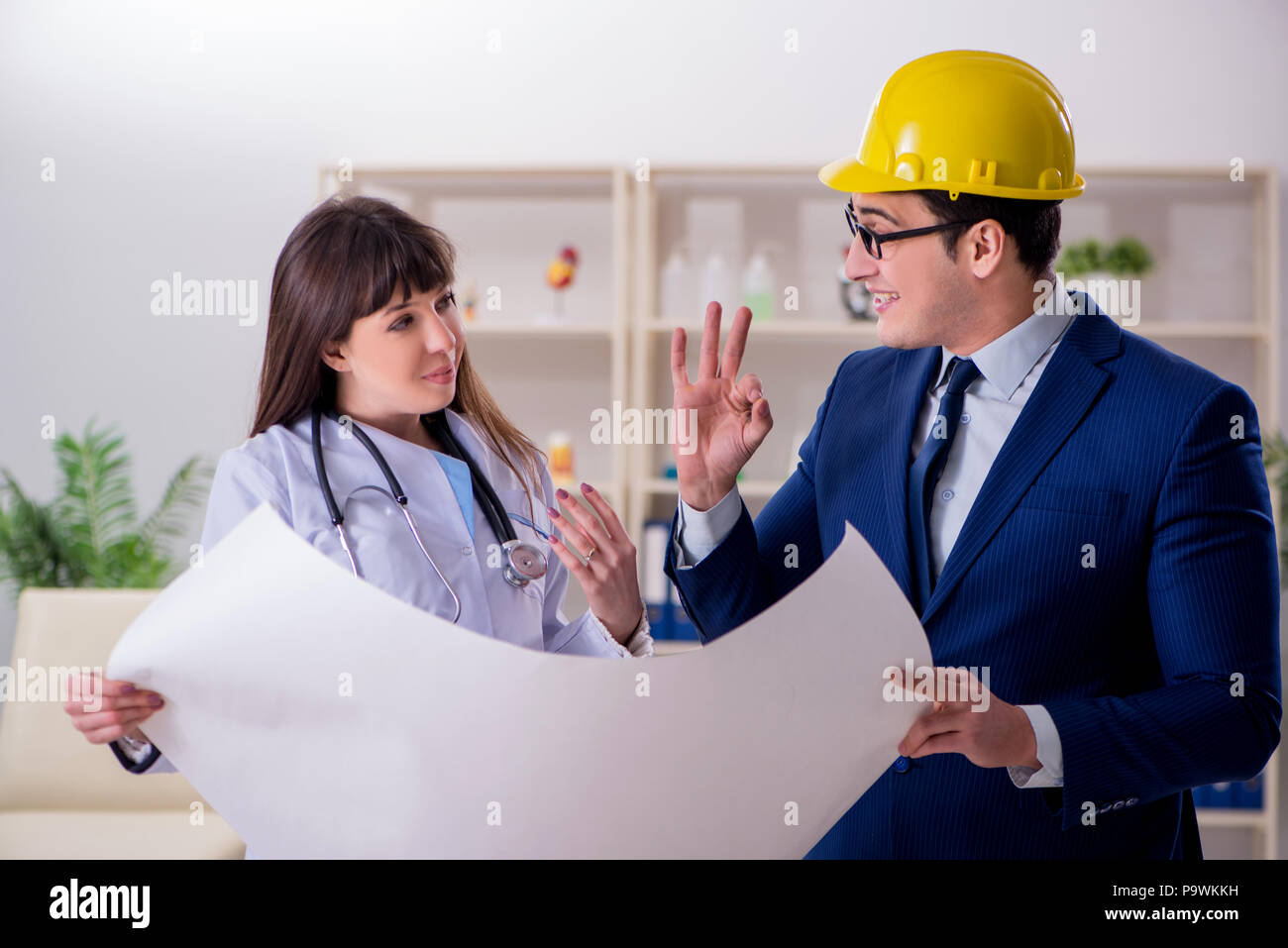 Doctor discussing new hospital plan with architect Stock Photo - Alamy