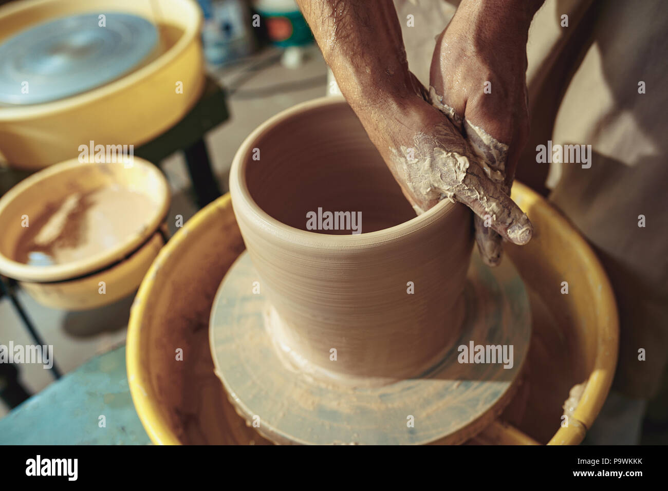 Creating a jar or vase of white clay close-up. Master crock Stock Photo ...