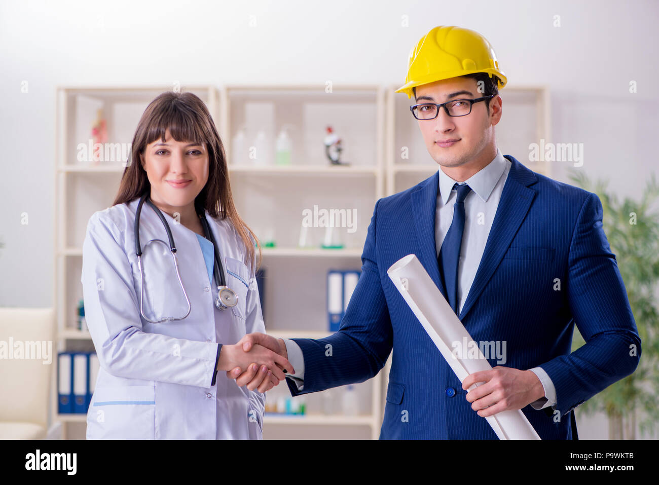 Doctor discussing new hospital plan with architect Stock Photo - Alamy