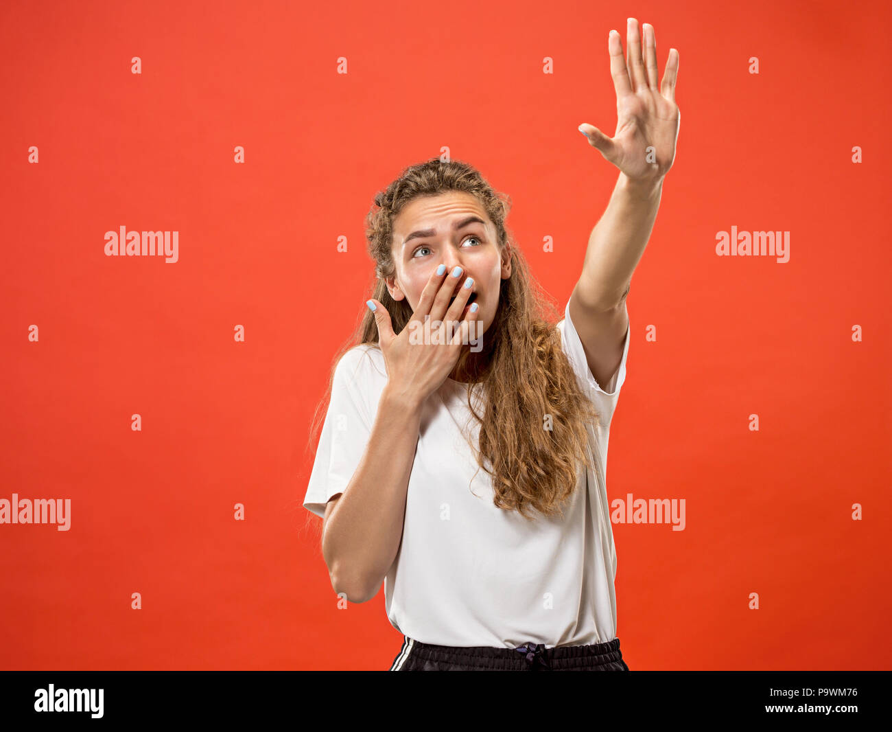 Portrait of the scared woman on red Stock Photo - Alamy