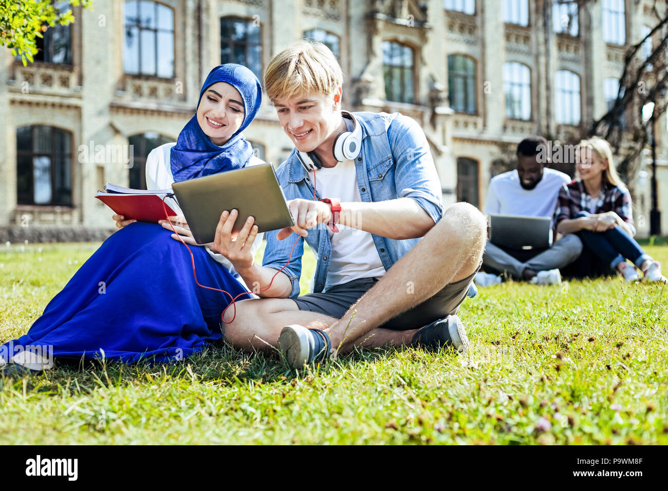 Living without boundaries. Two multicultural mates smiling while ...