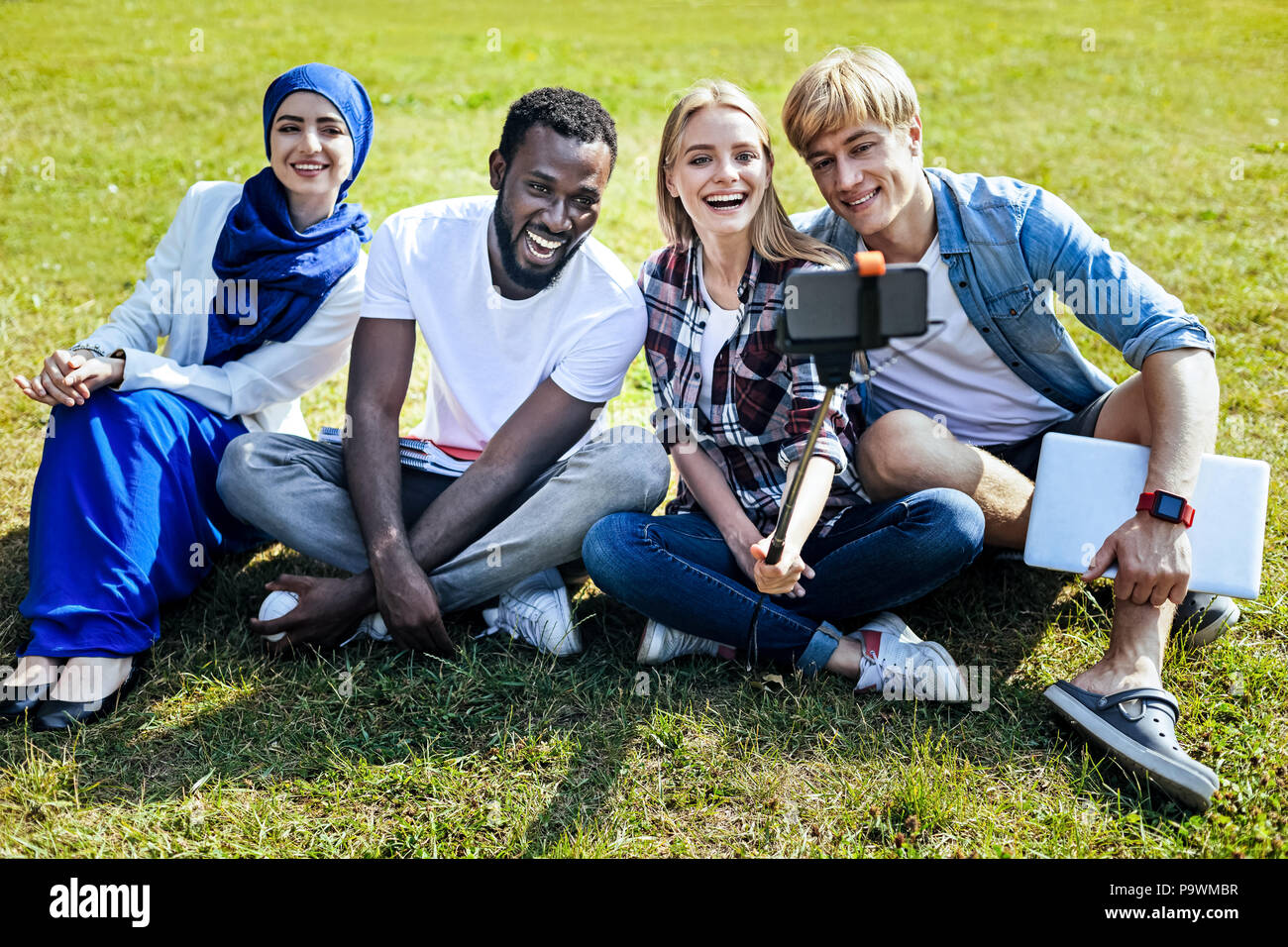 Never bored together. Group of multicultural college mates sitting on ...