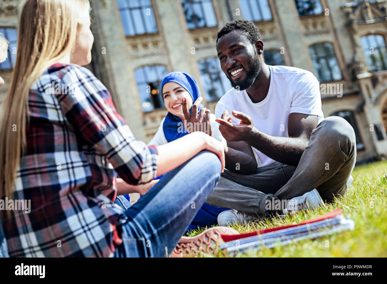 Extremely happy mates enjoying pleasant conversation Stock Photo - Alamy