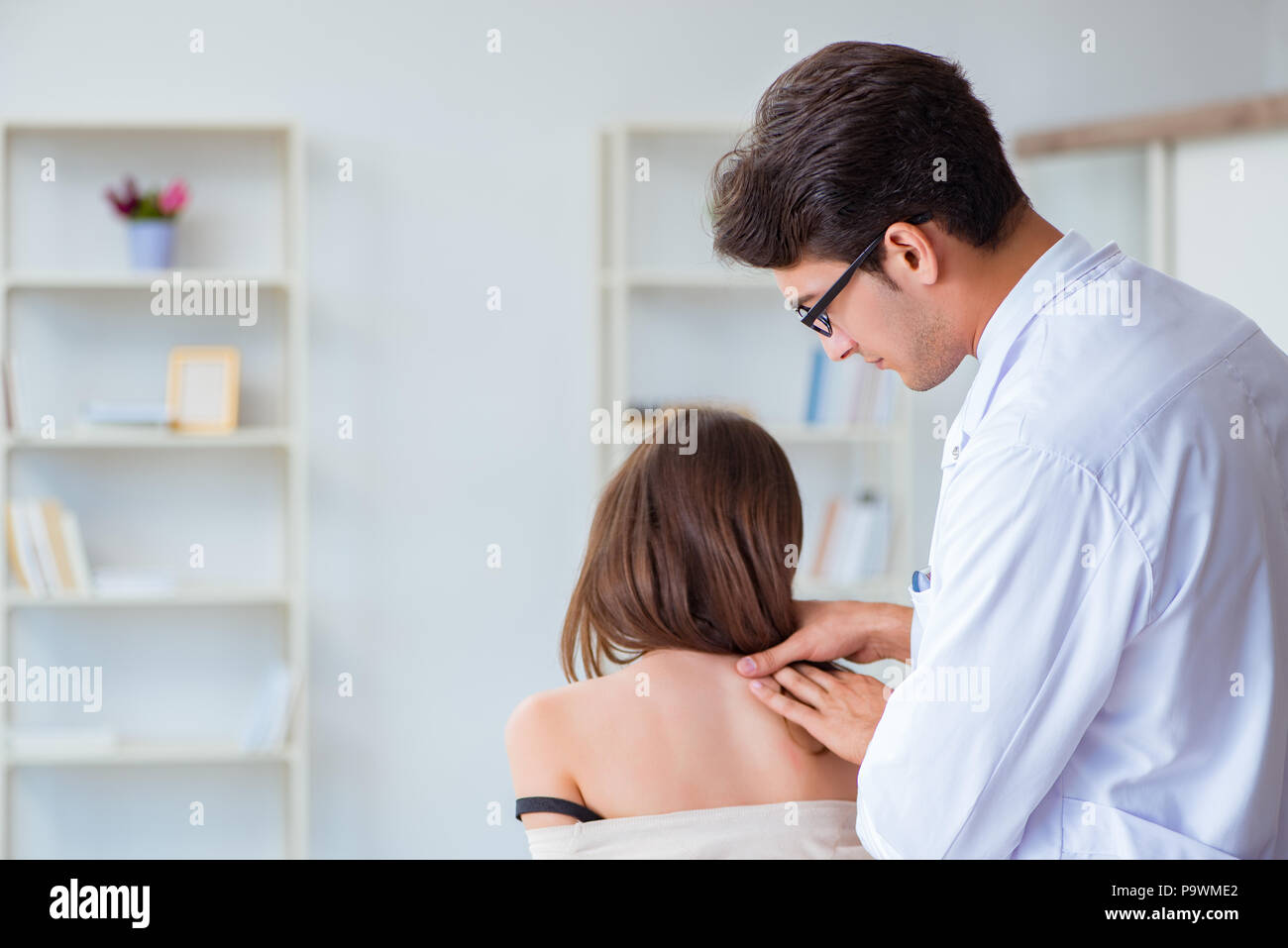 Doctor examining the skin of female patient Stock Photo - Alamy