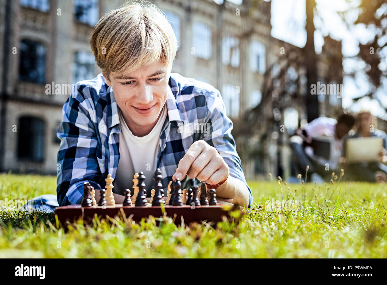 Handsome young man playing chess outdoors Stock Photo - Alamy