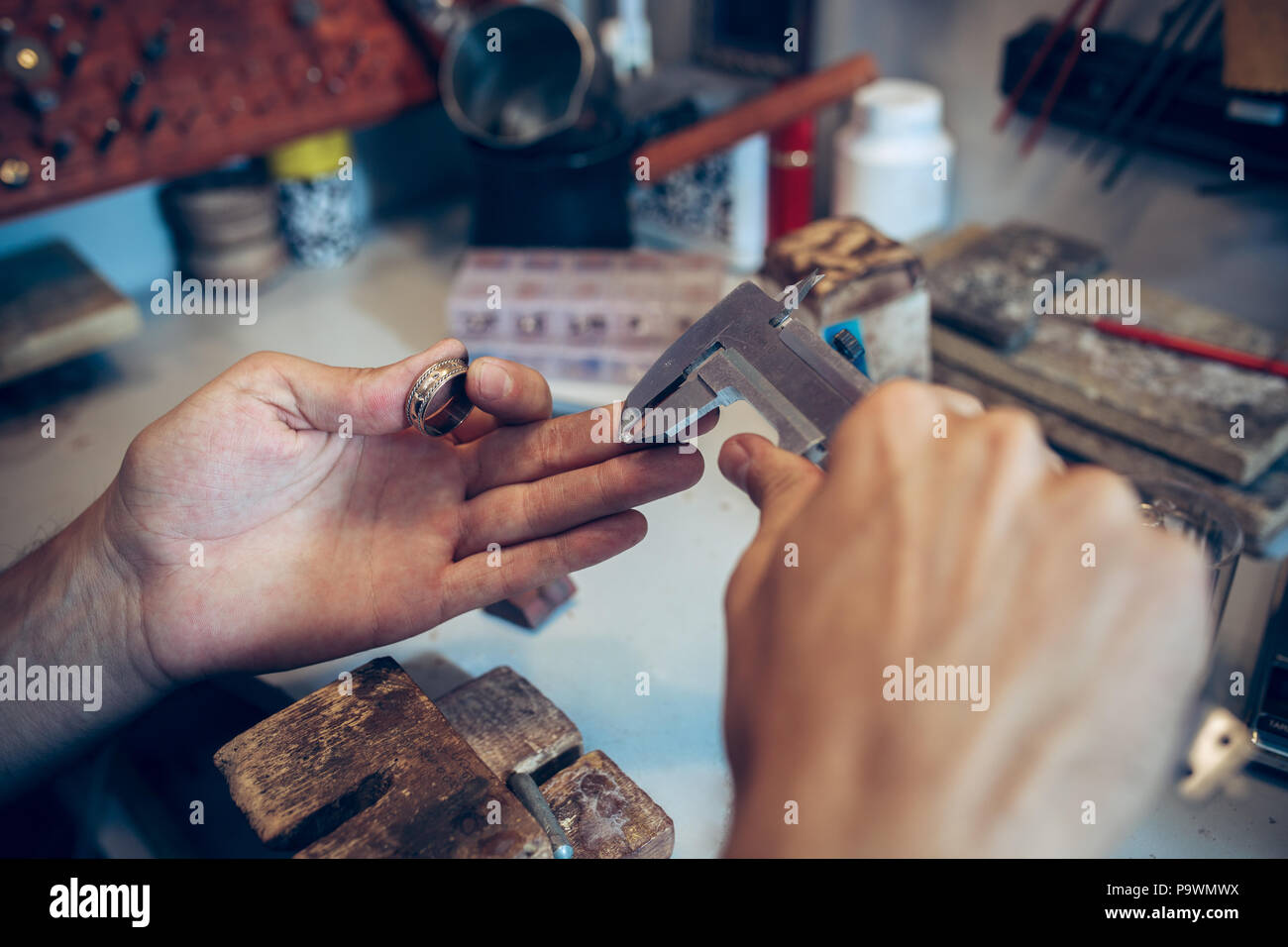 Different goldsmiths tools on the jewelry workplace. Jeweler at work in ...