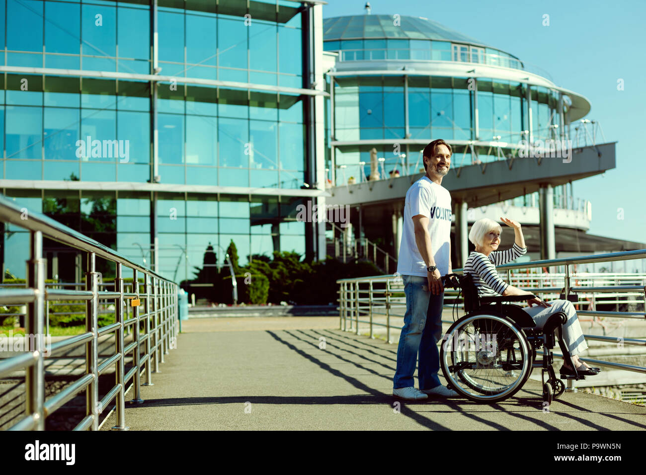 Handsome male person helping his client Stock Photo - Alamy