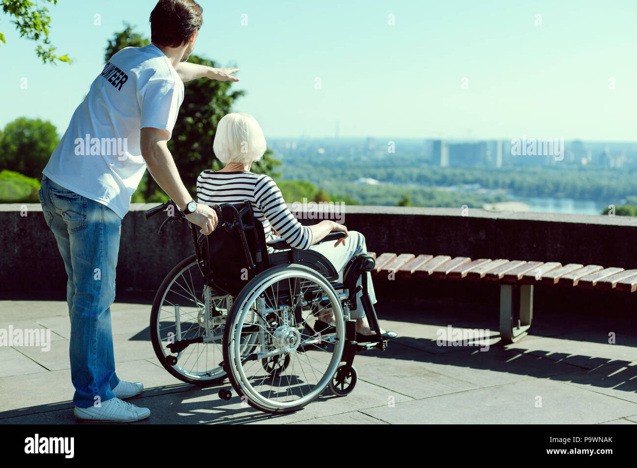 Back view of disabled woman that listening her helper Stock Photo - Alamy