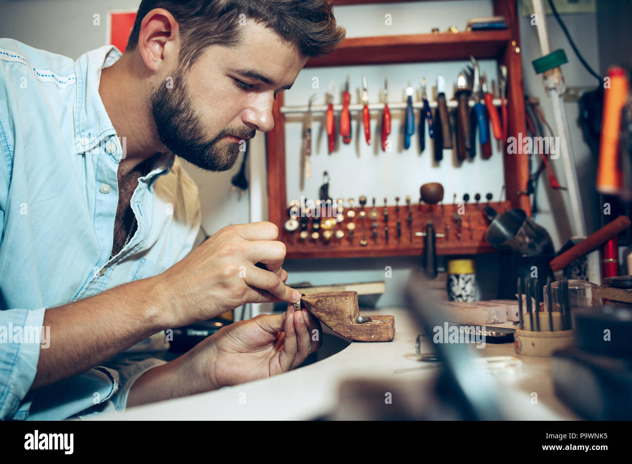 Different goldsmiths tools on the jewelry workplace. Jeweler at work in ...