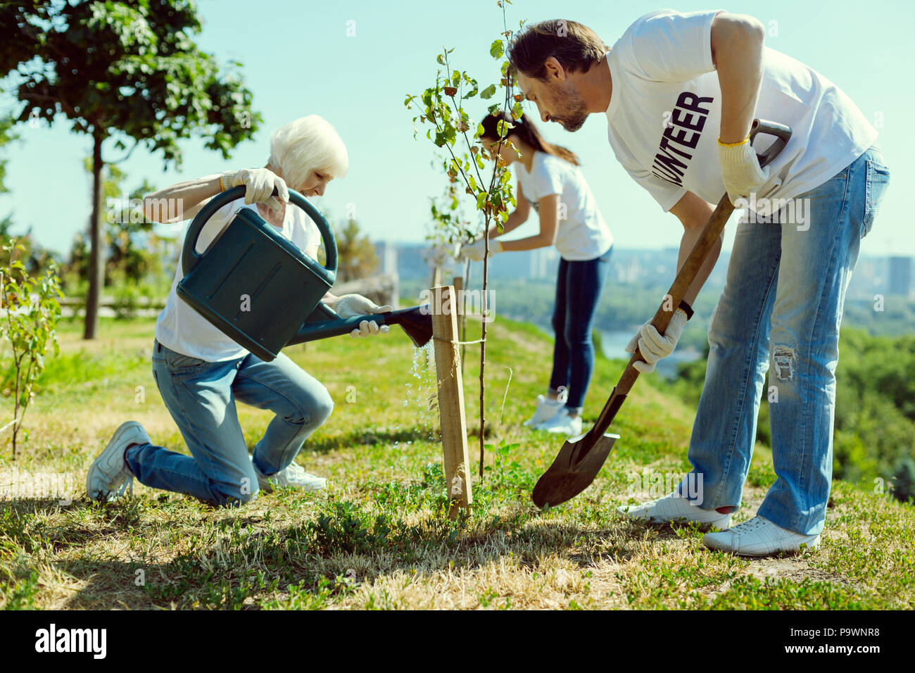 Serious man using heavy spade Stock Photo - Alamy