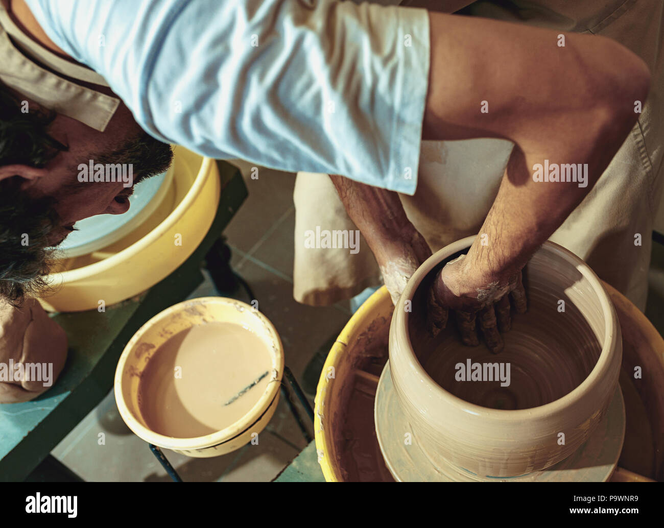Creating a jar or vase of white clay close-up. Master crock Stock Photo ...