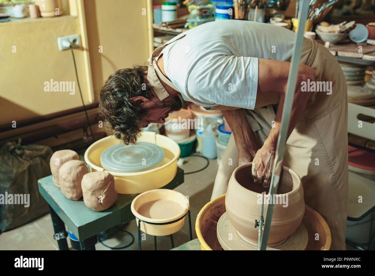 Creating a jar or vase of white clay close-up. Master crock Stock Photo ...