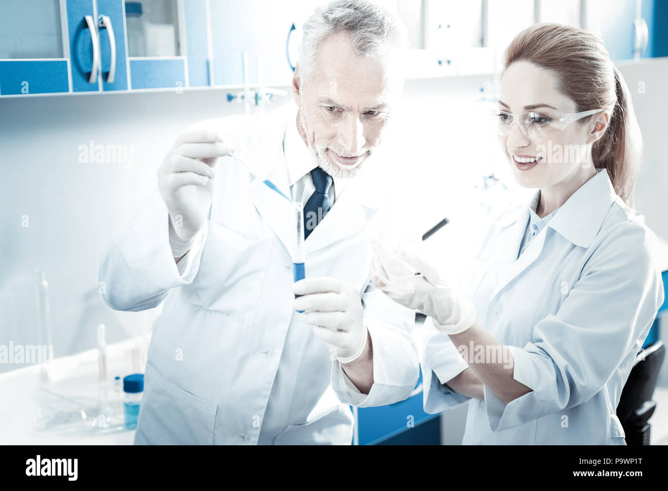 Positive professional scientists working in the lab together Stock ...