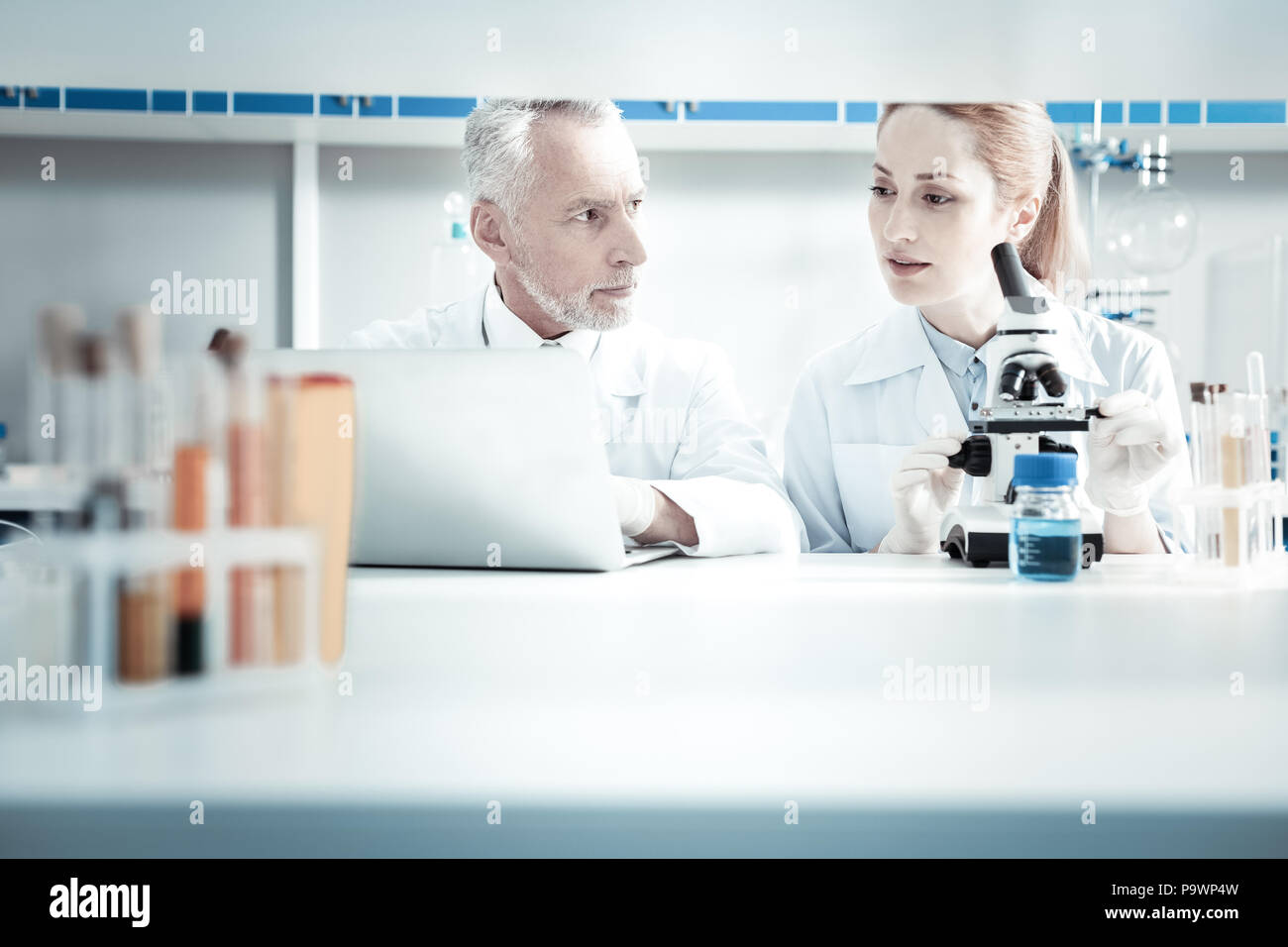 Nice professional scientists sitting together Stock Photo - Alamy