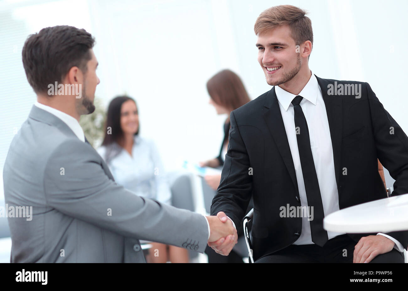 handshake Manager and the client in the office Stock Photo - Alamy