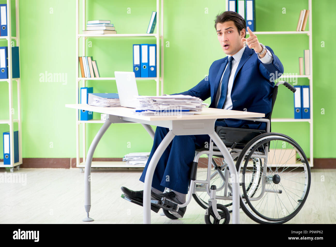 Disabled businessman working in the office Stock Photo - Alamy