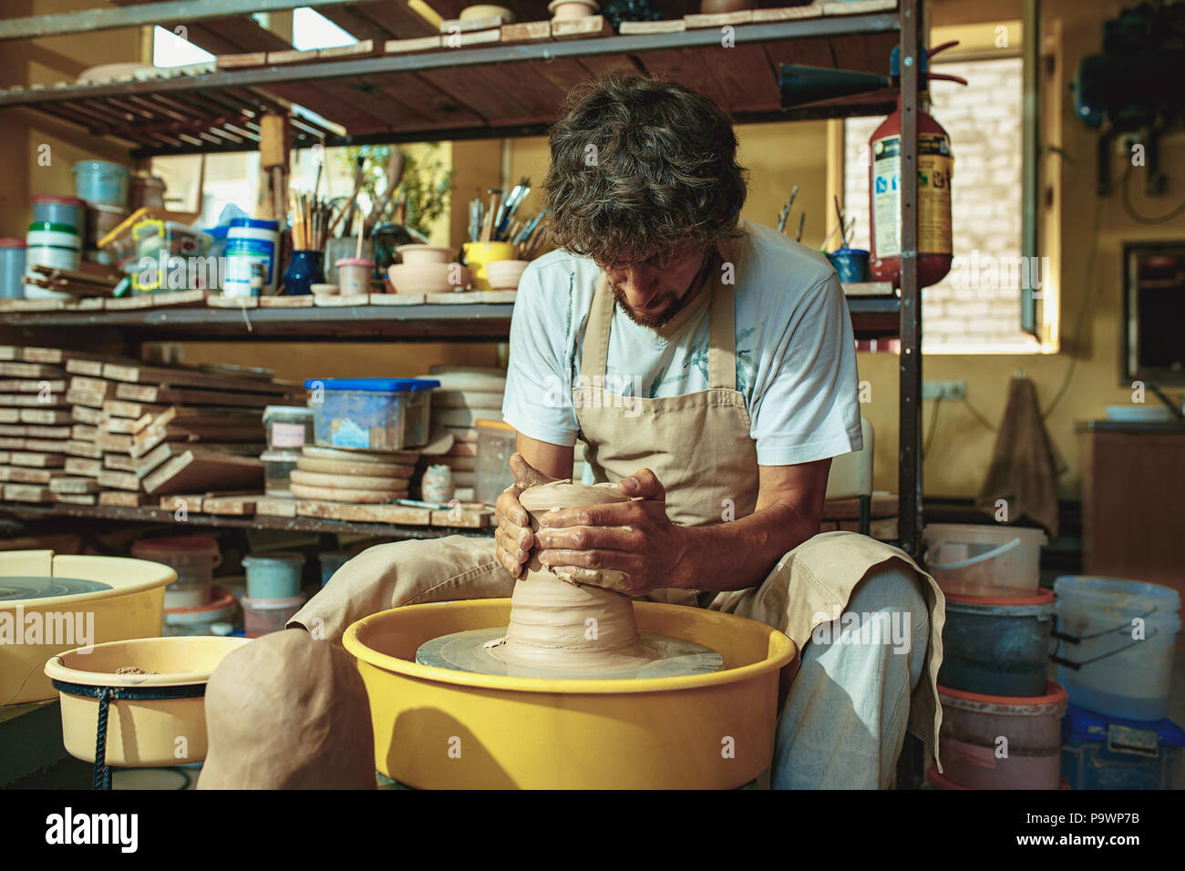 Creating a jar or vase of white clay close-up. Master crock Stock Photo ...