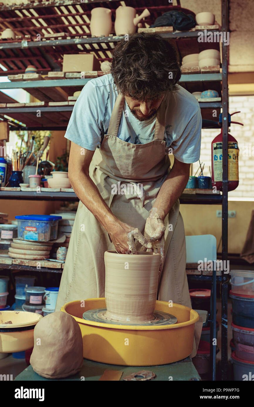 Creating a jar or vase of white clay close-up. Master crock Stock Photo ...