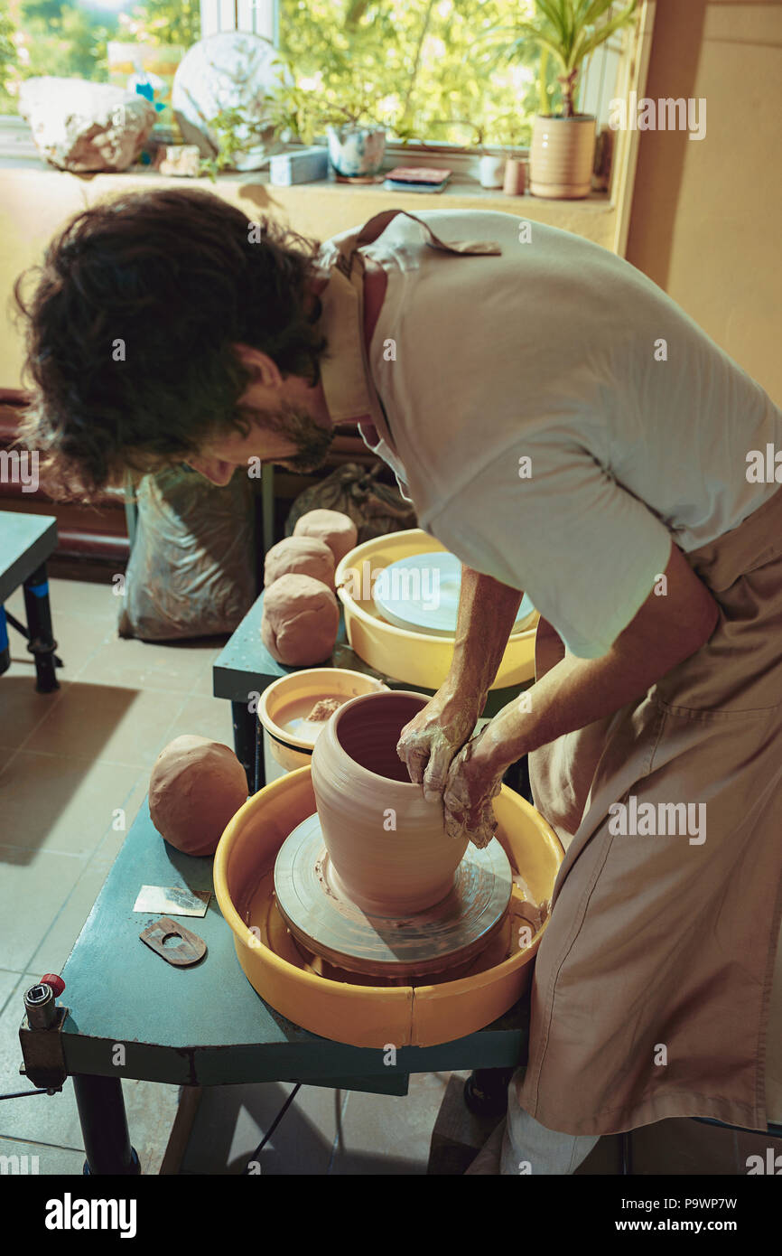 Creating a jar or vase of white clay close-up. Master crock Stock Photo ...