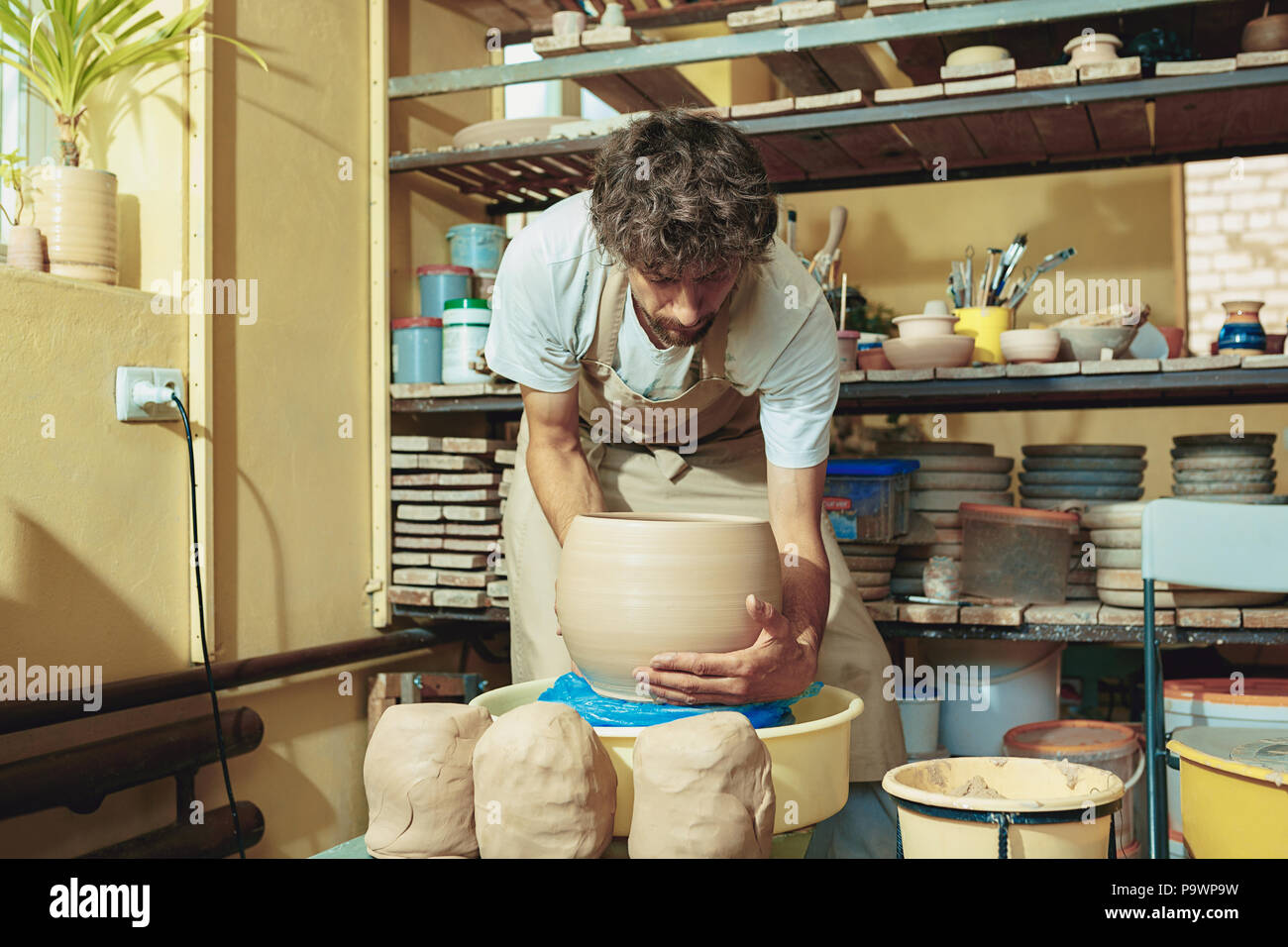 Creating a jar or vase of white clay close-up. Master crock Stock Photo ...