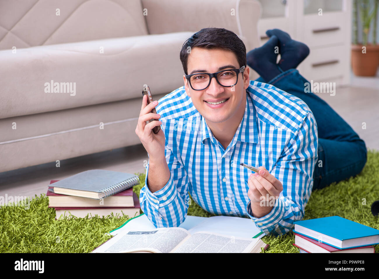 Young student preparing for exams at home Stock Photo - Alamy
