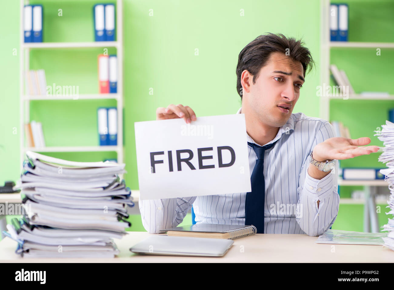 Businessman having problems with paperwork and workload Stock Photo - Alamy