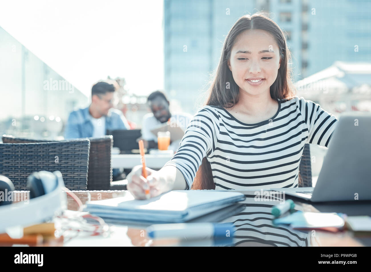 Attractive international girl doing her job Stock Photo - Alamy