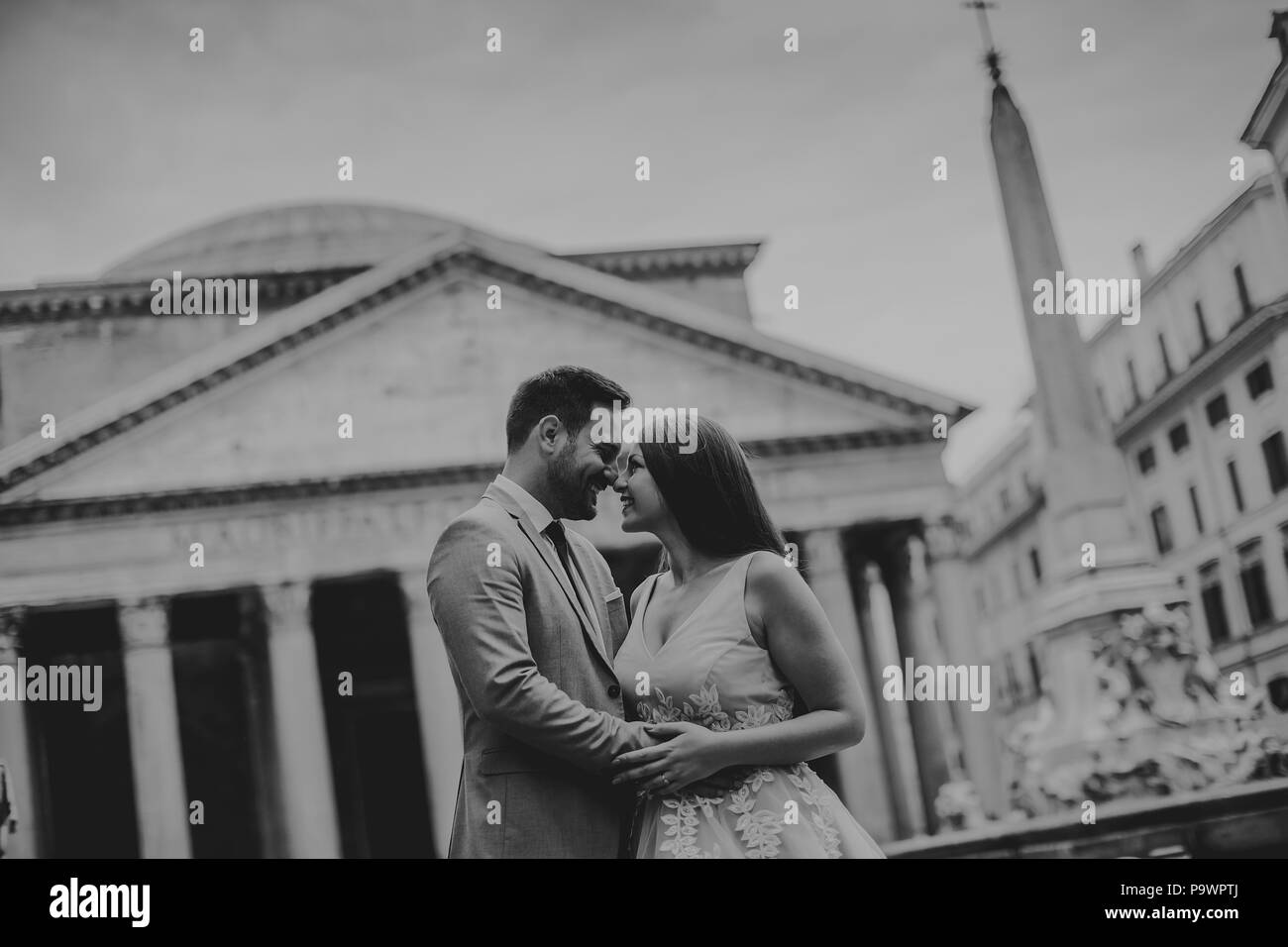 Young attractive newly married couple posing in Rome with beautiful and ...