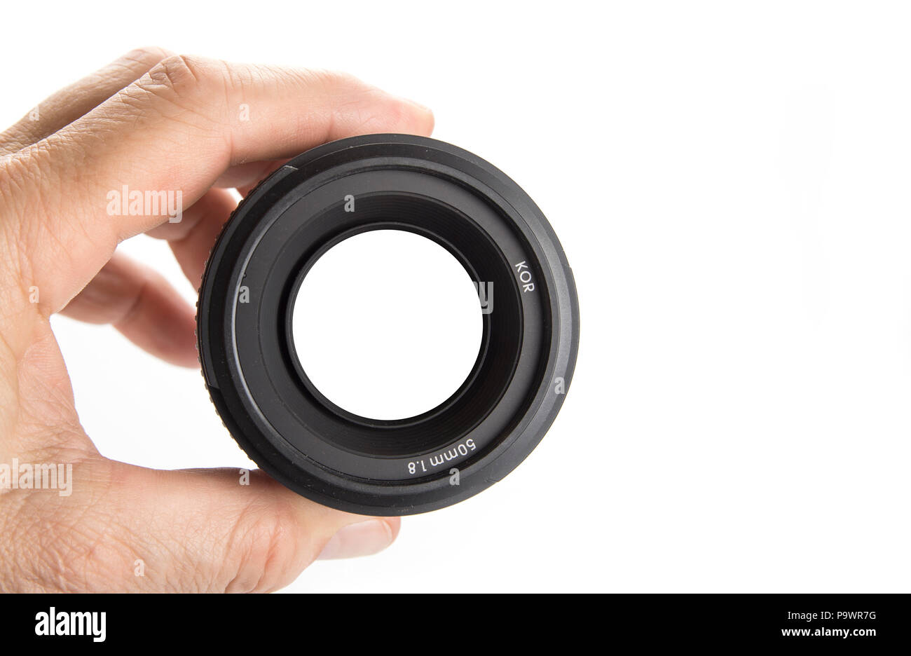 Hand holding camera lens on the white with the sign focus on Stock ...