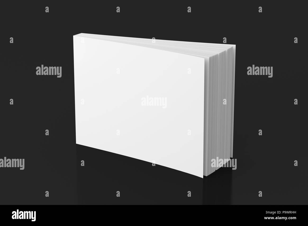 Blank white horizontal soft cover book standing on black background ...